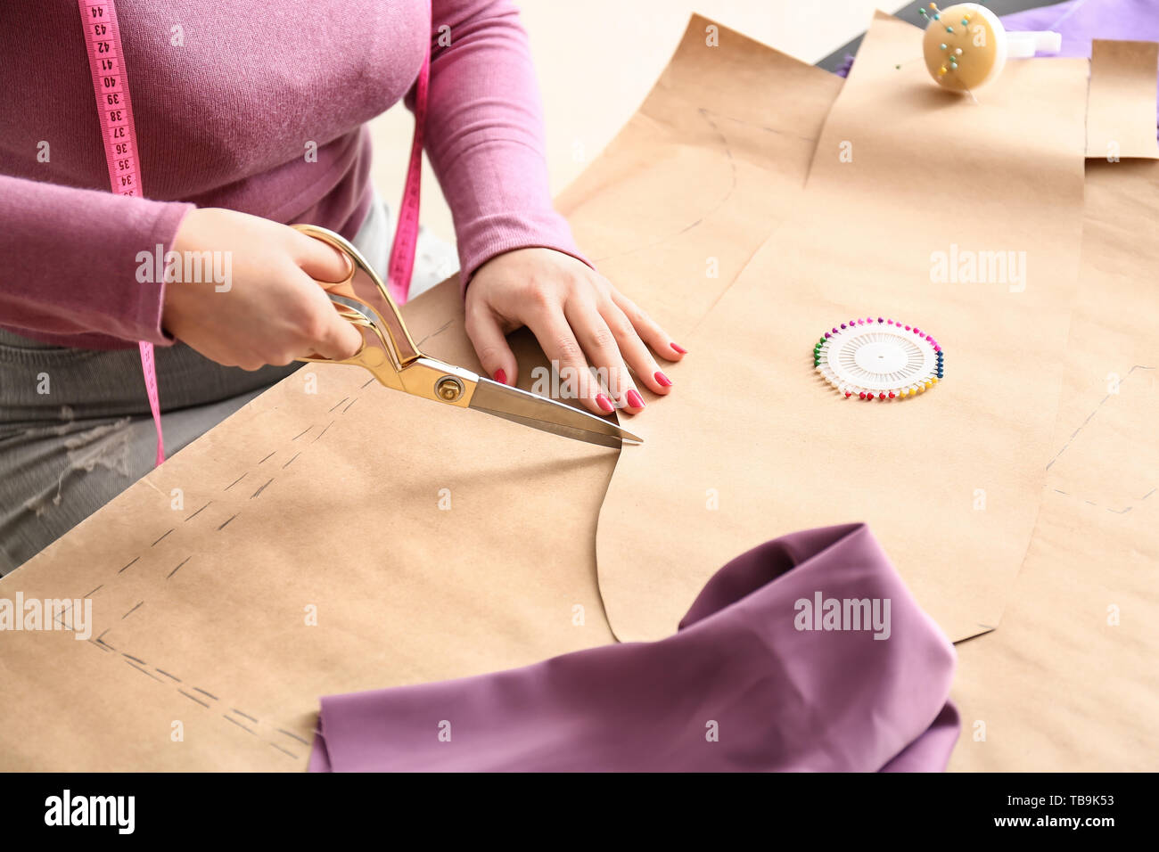 Female tailor working with sewing patterns in atelier Stock Photo - Alamy