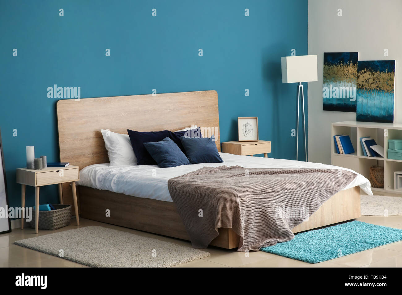 Big comfortable bed in stylish interior of room Stock Photo - Alamy