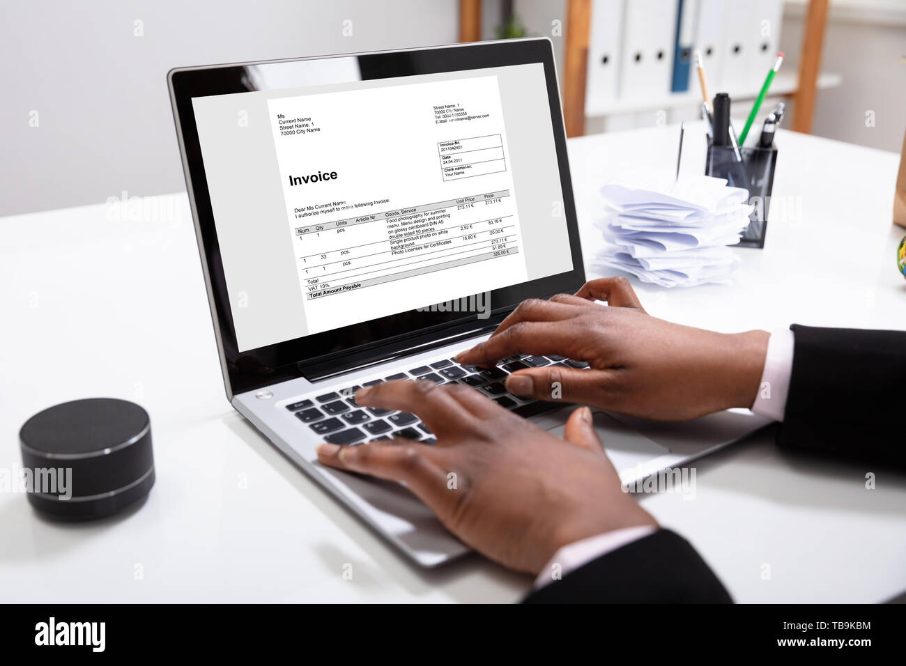 Close-up Of A Businesswoman's Hand Checking Invoice On Laptop Near ...