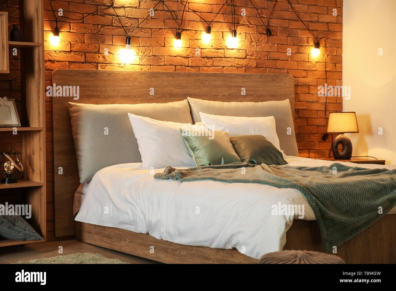 Big comfortable bed in stylish interior of room Stock Photo - Alamy