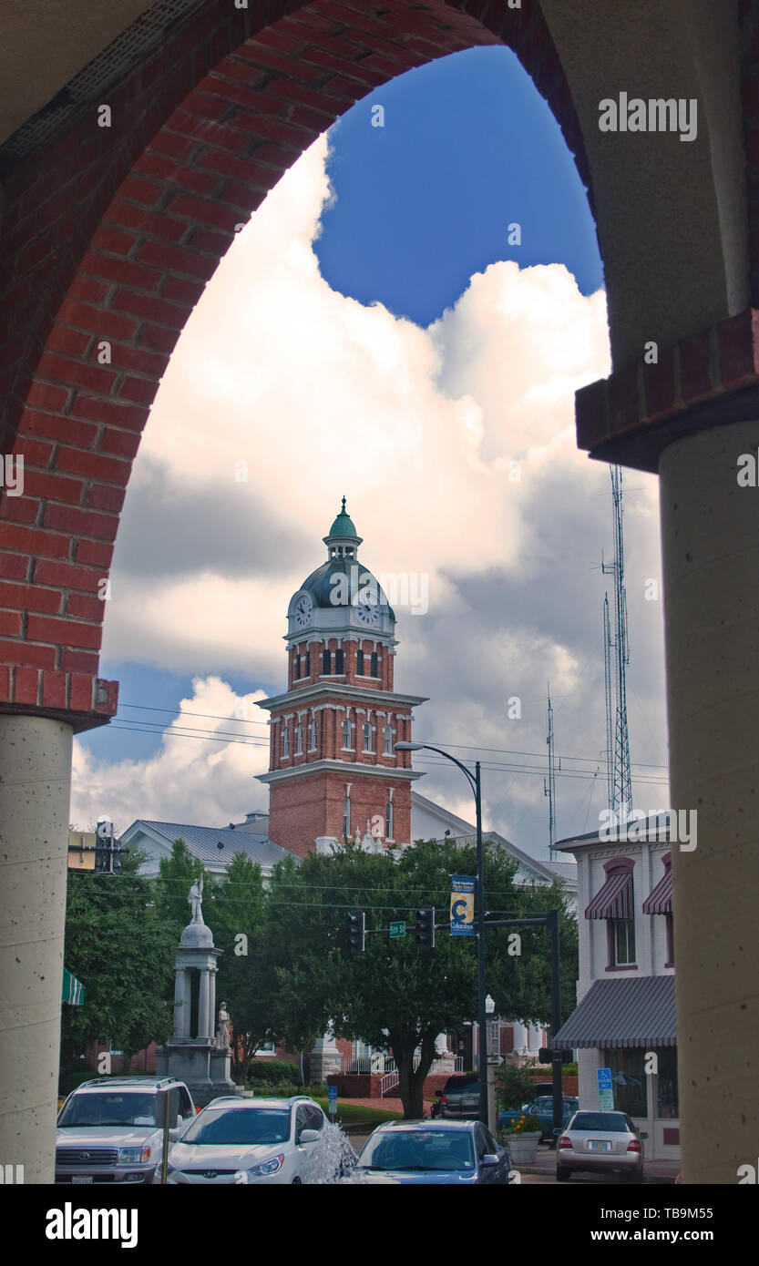 The Lowndes County Courthouse clock tower is framed by the archway of ...
