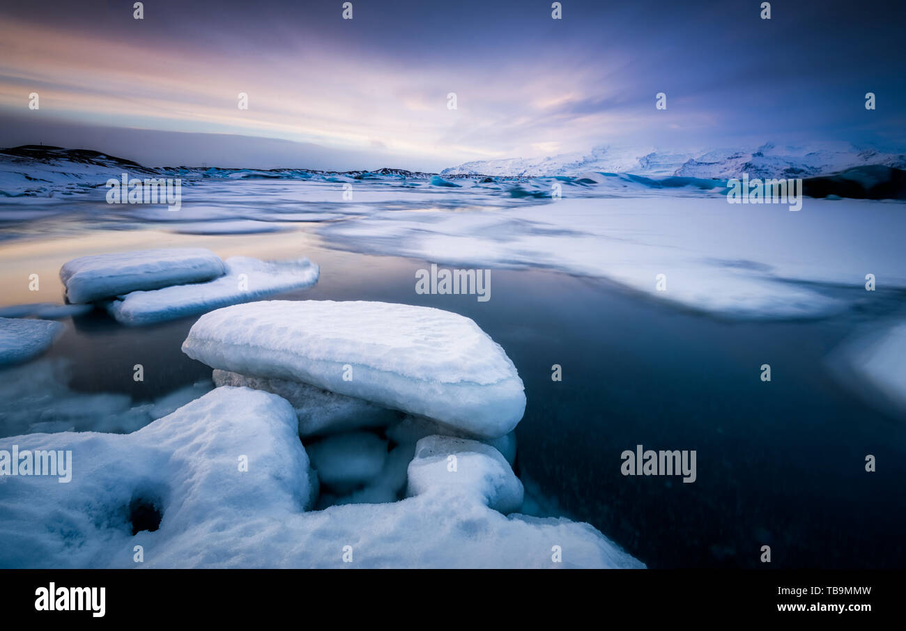 Ice lake behind snow Stock Photo - Alamy