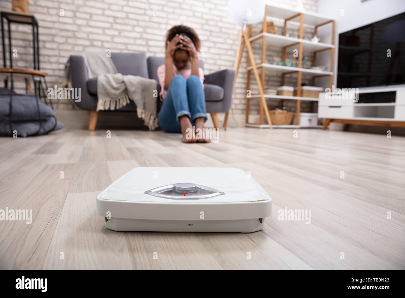 Close-up Of A Weighing Scale In Front Of Upset Woman Stock Photo - Alamy