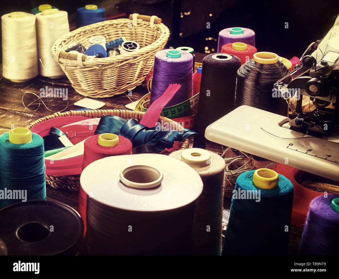 Coil overlock threads and measuring tape in light sun flare Stock Photo ...