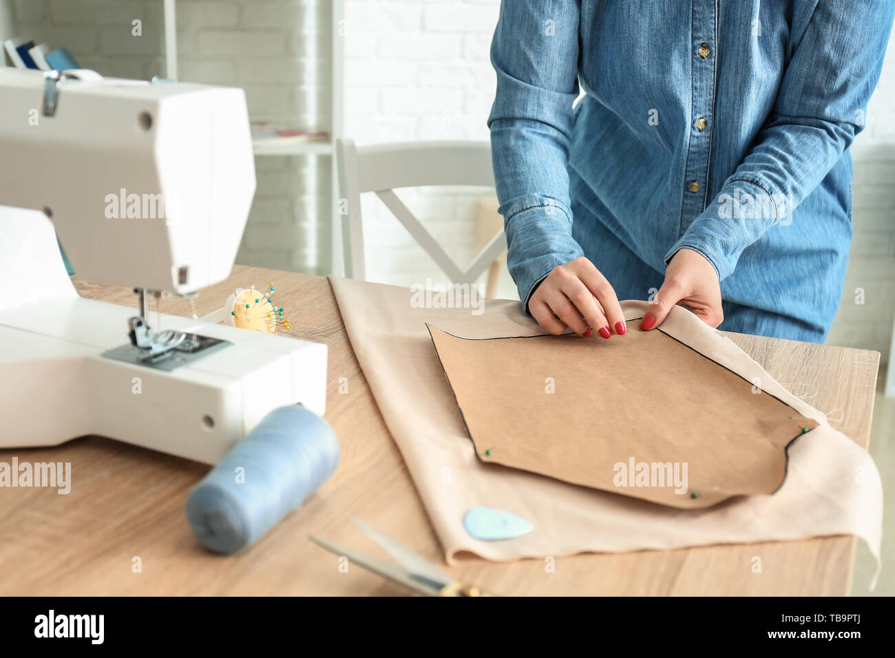 Female tailor working with sewing patterns in atelier Stock Photo - Alamy