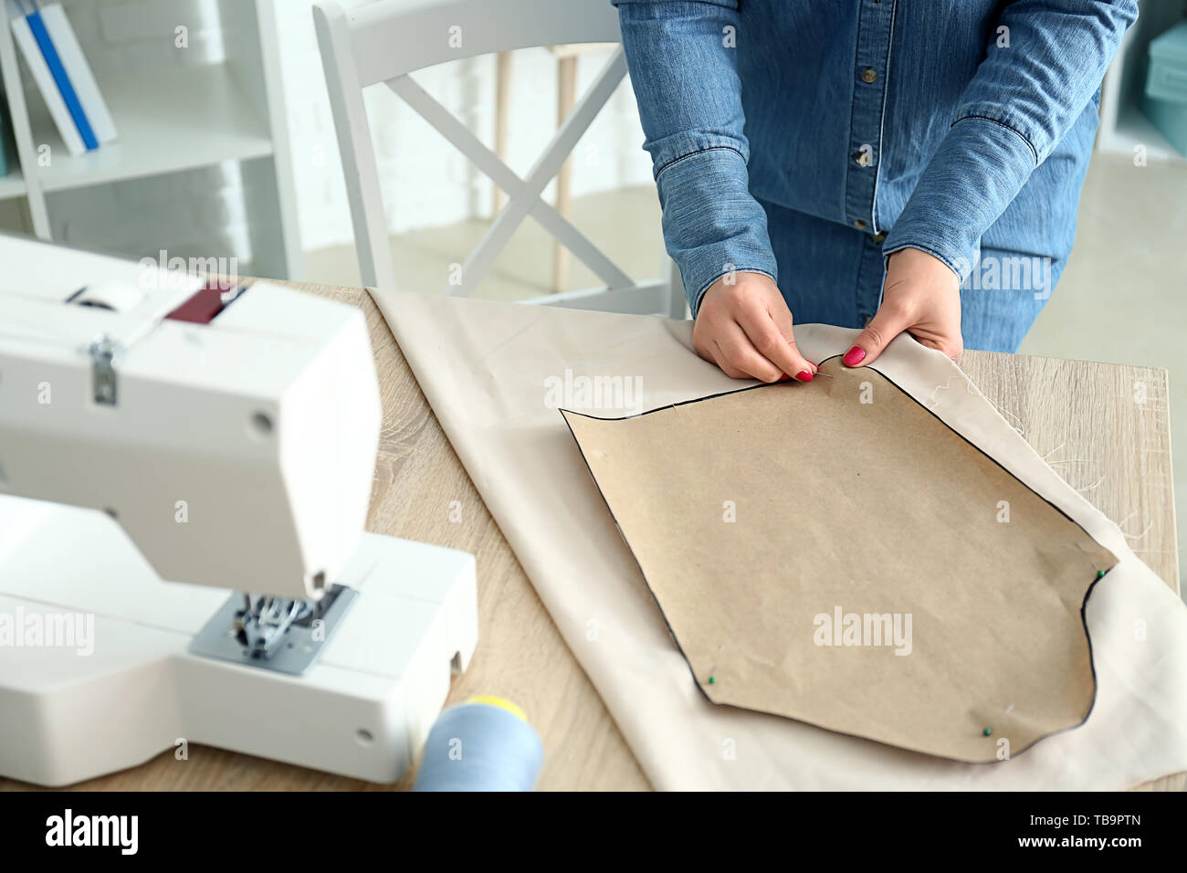 Female tailor working with sewing patterns in atelier Stock Photo - Alamy