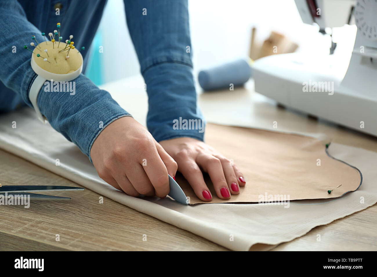 Female tailor working with sewing patterns in atelier Stock Photo - Alamy