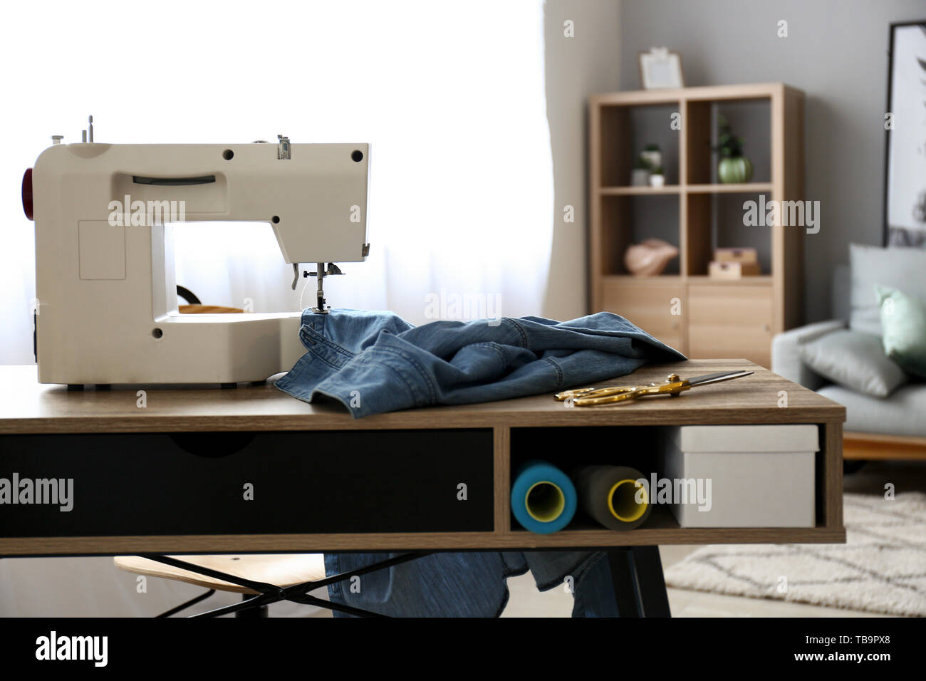 Sewing machine on tailor's workplace in atelier Stock Photo - Alamy