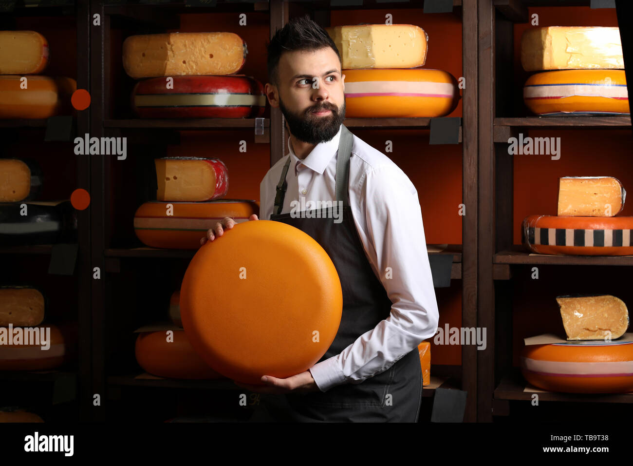 Young man cheese wheel hi-res stock photography and images - Alamy