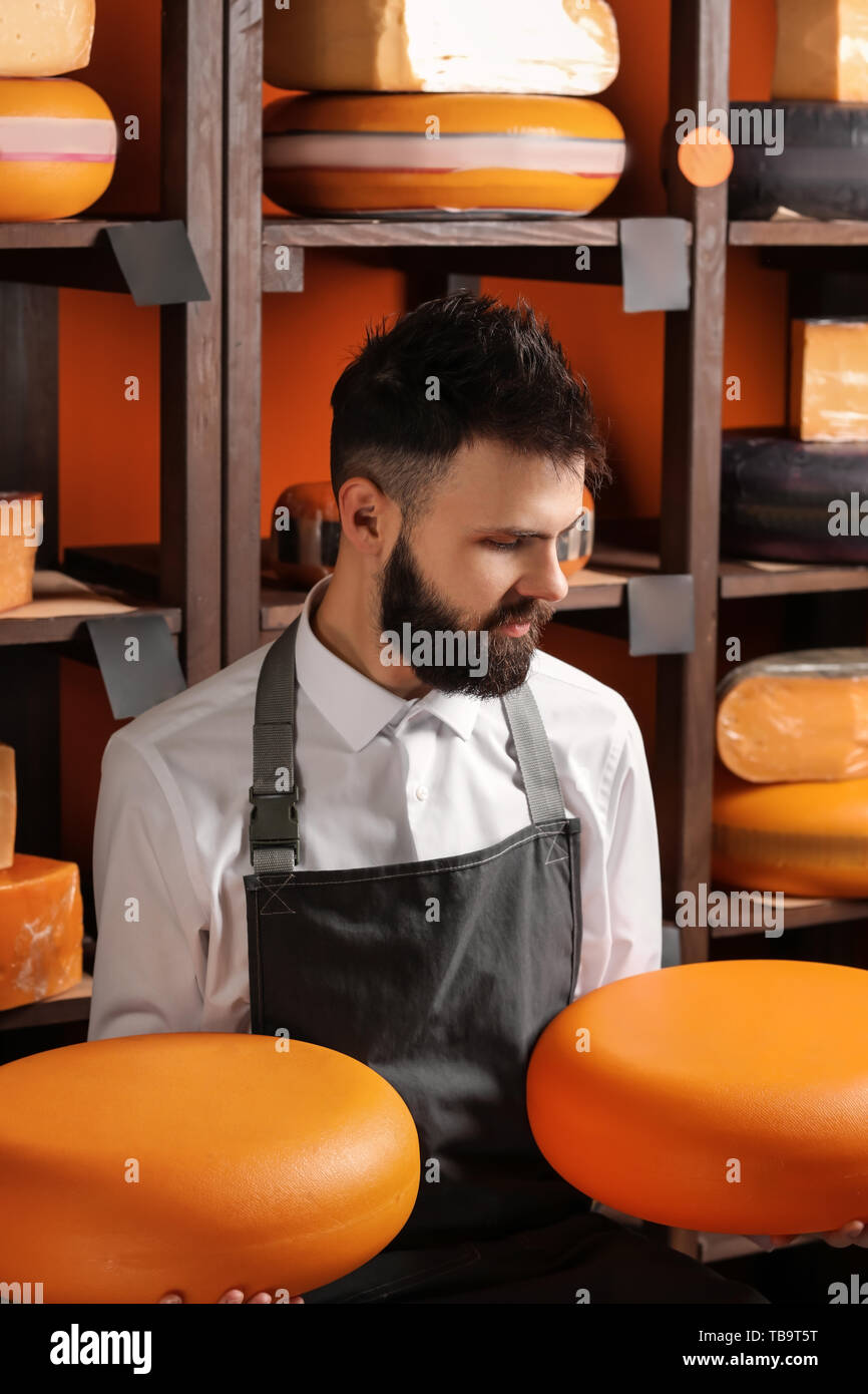 Young man cheese wheel hi-res stock photography and images - Alamy