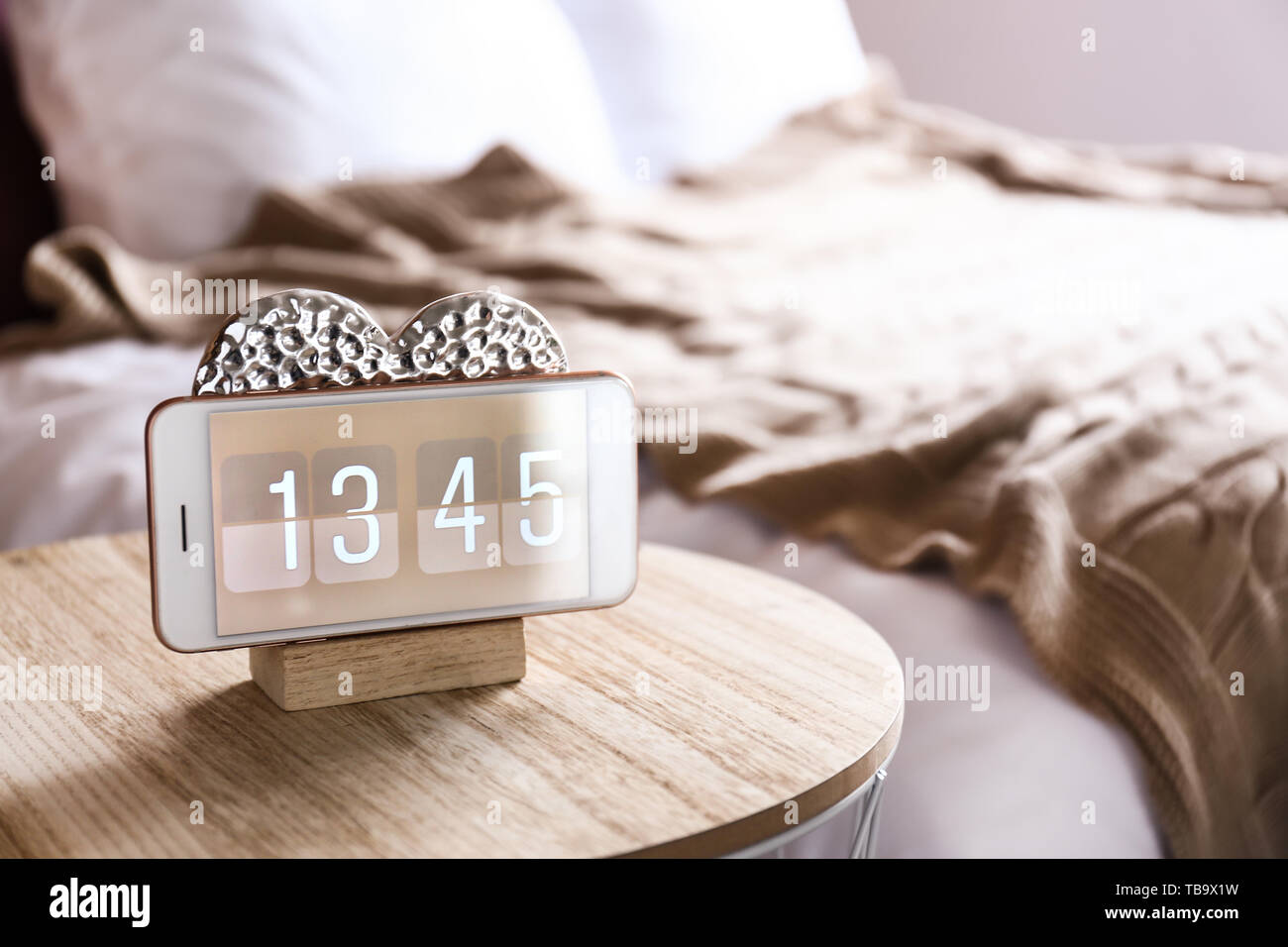 Mobile phone with Clock application on screen in bedroom Stock Photo ...