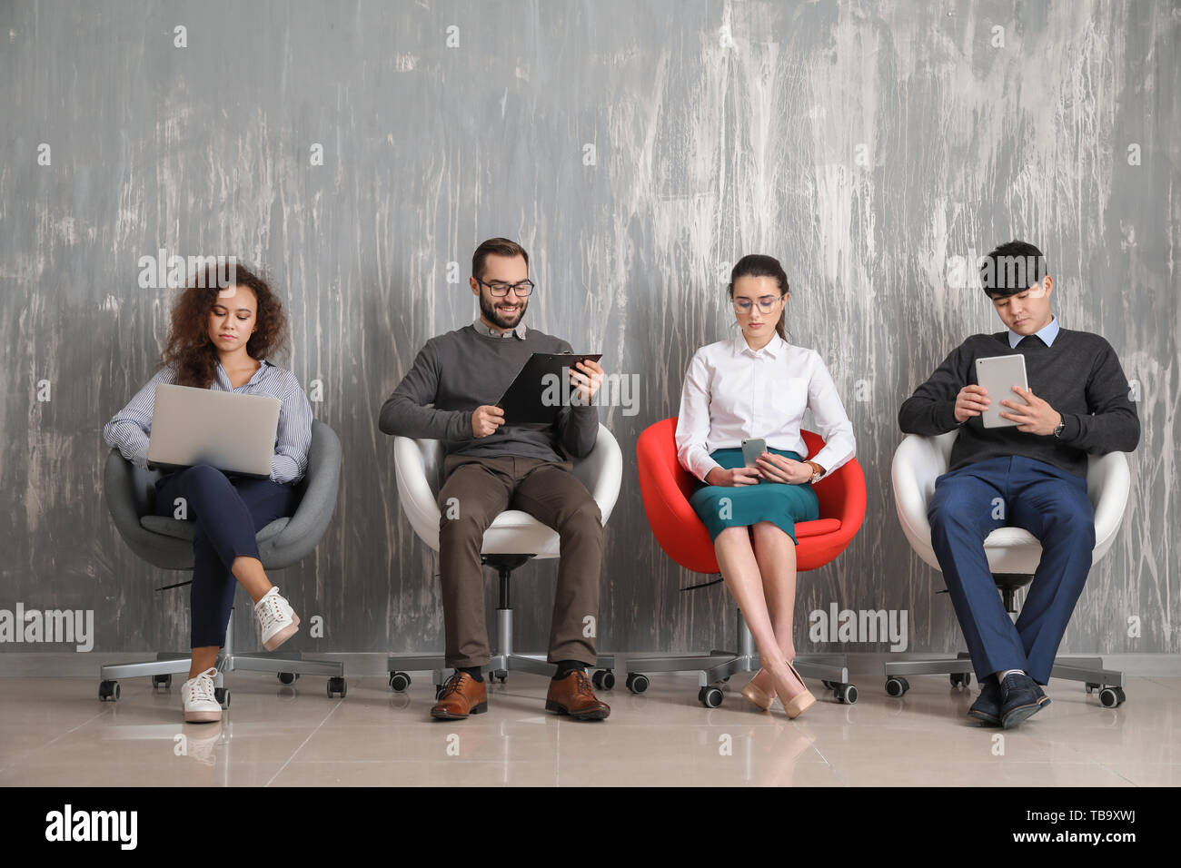 Young people waiting for job interview indoors Stock Photo - Alamy