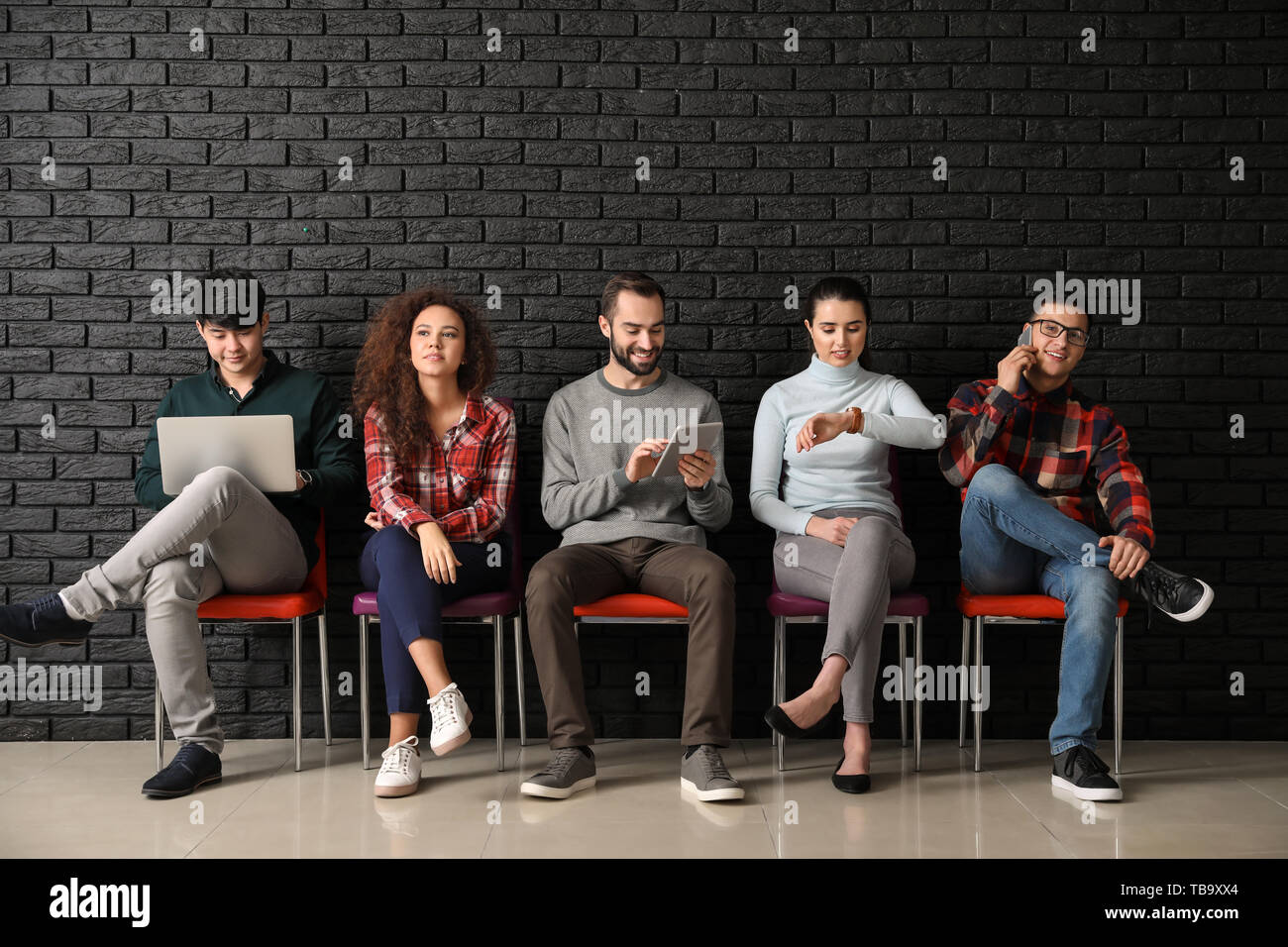 Young people waiting for job interview indoors Stock Photo - Alamy