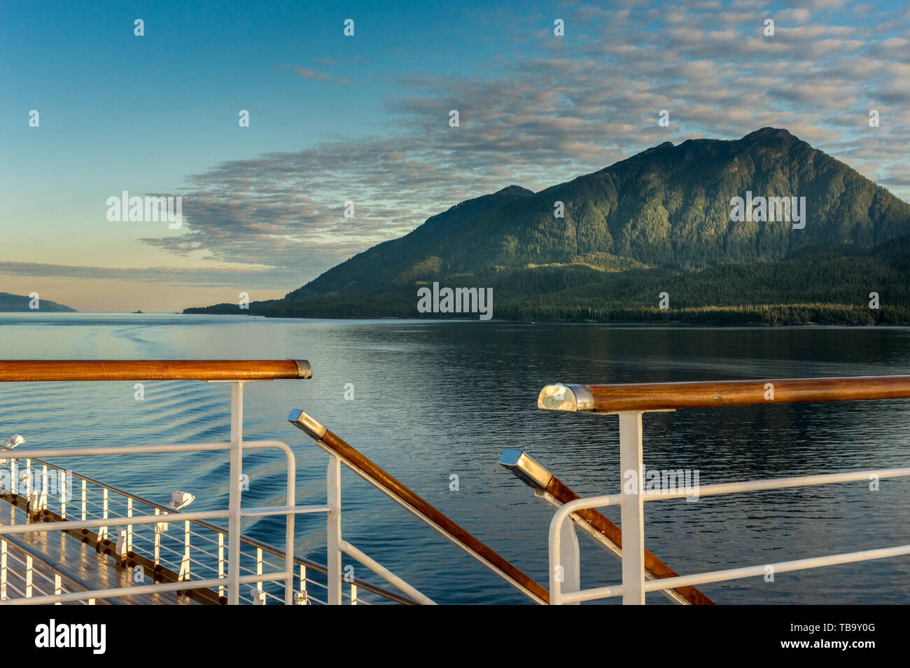 Railing and stairs, top deck of cruise ship, in golden early morning ...