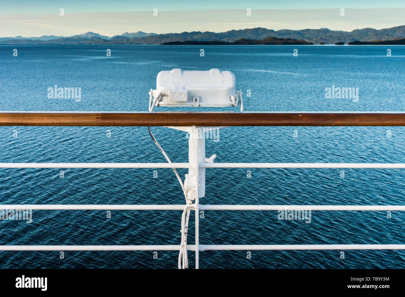 White metal marine exterior light fixture on railing of cruise ship ...
