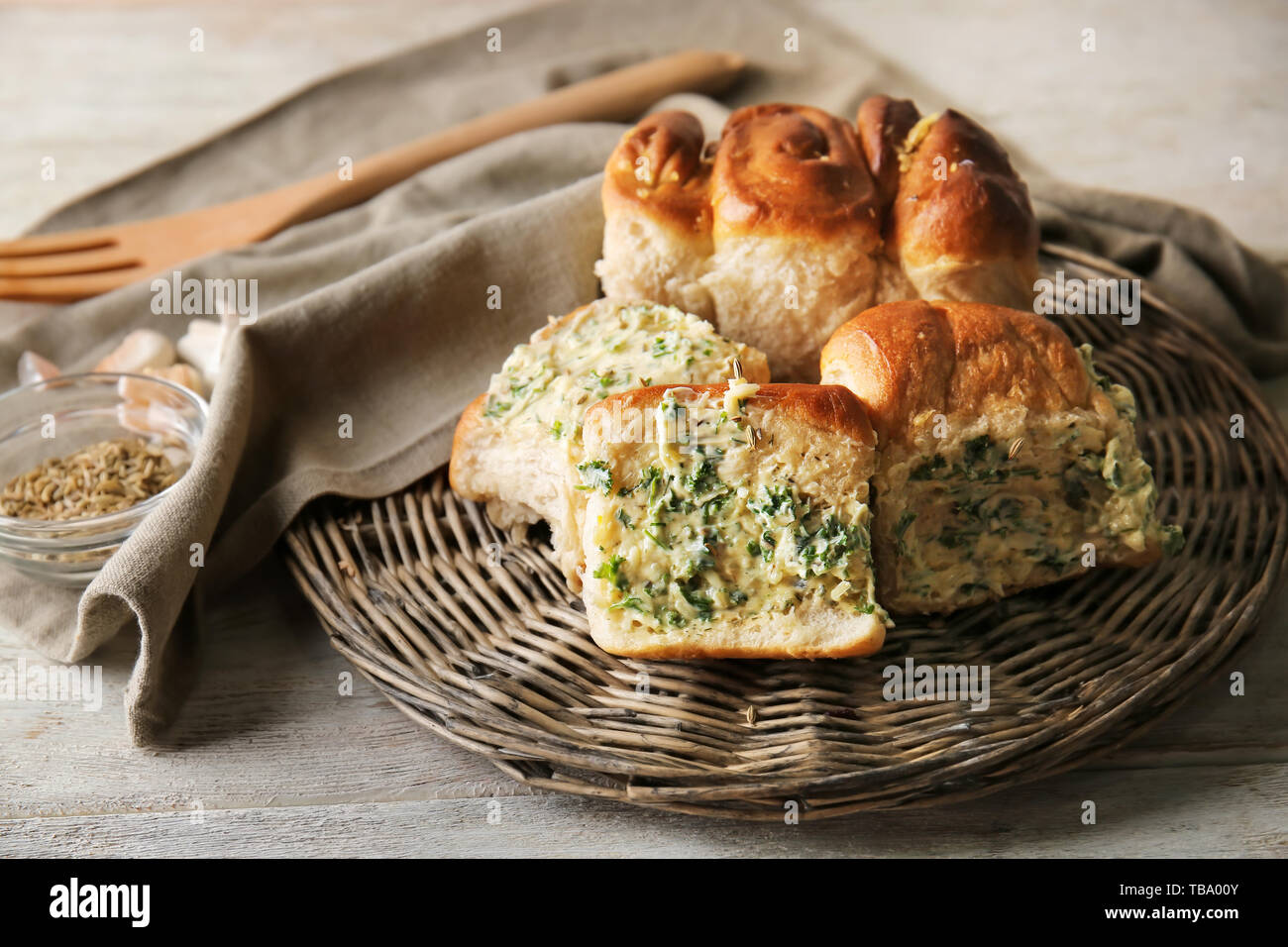 Tasty buns with garlic spreading on table Stock Photo - Alamy