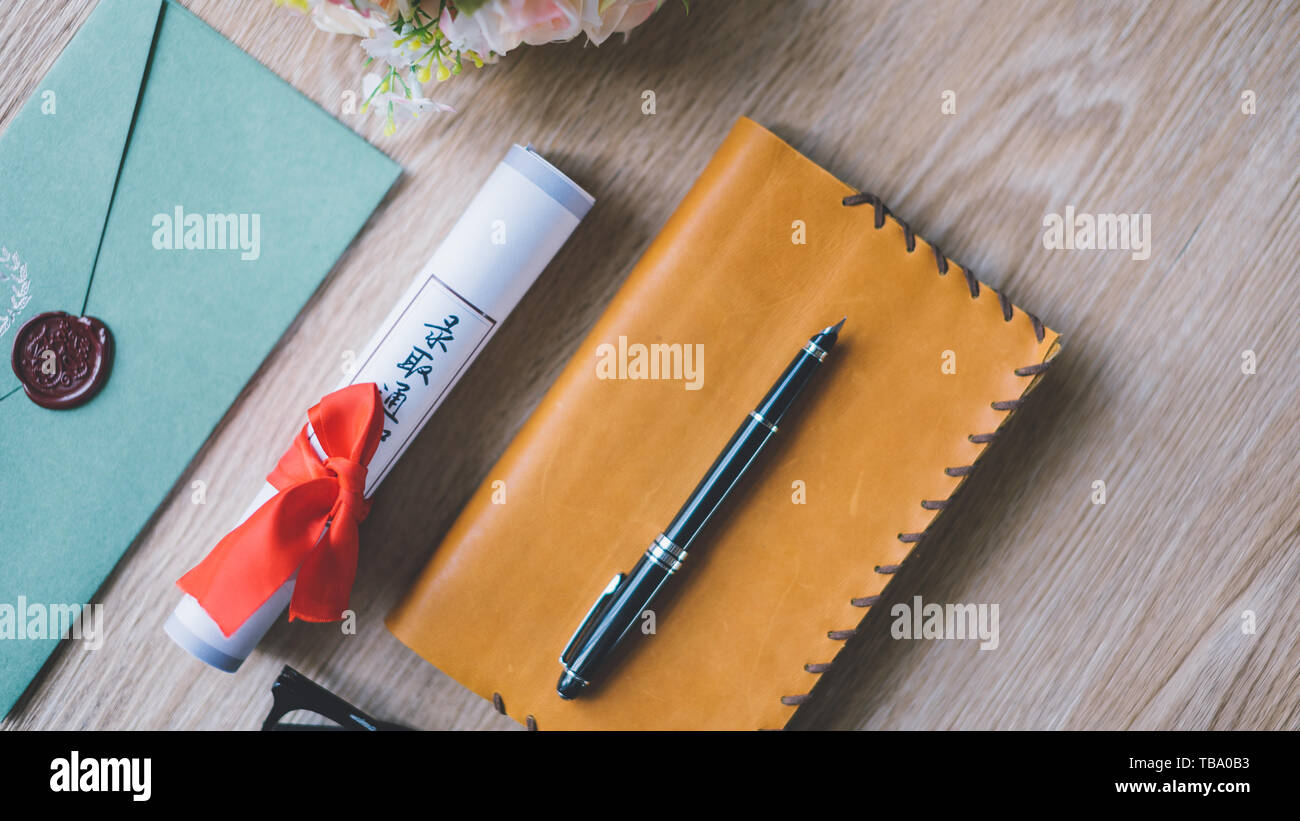 Acceptance letter, envelope, notebook on the table Stock Photo - Alamy