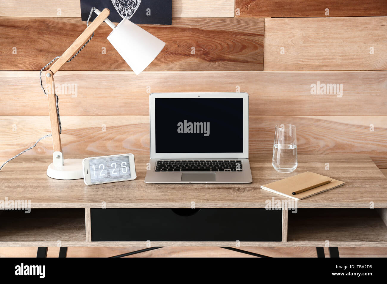 Laptop and mobile phone with running clock application on table Stock ...