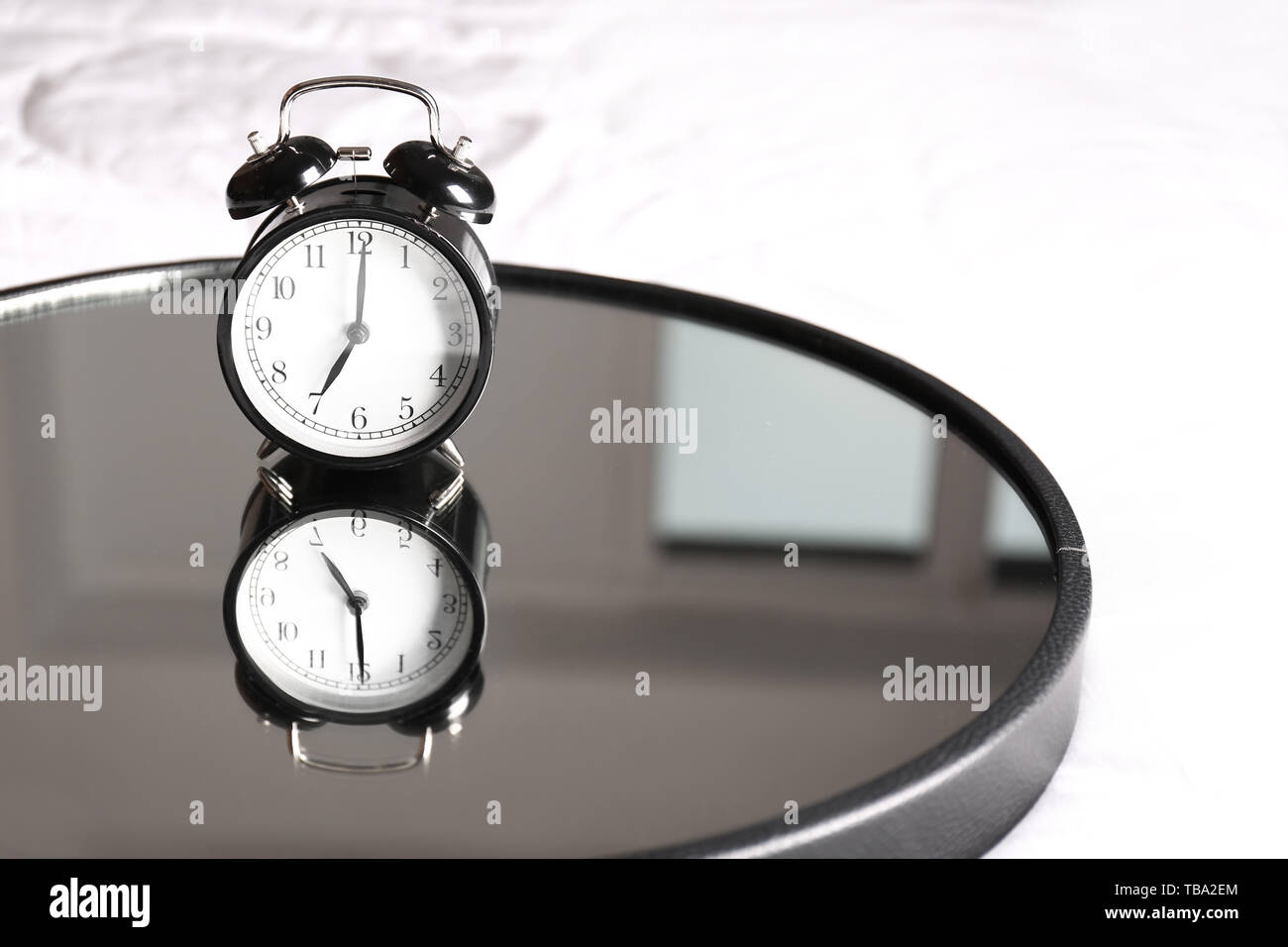 Alarm clock on table in room Stock Photo - Alamy
