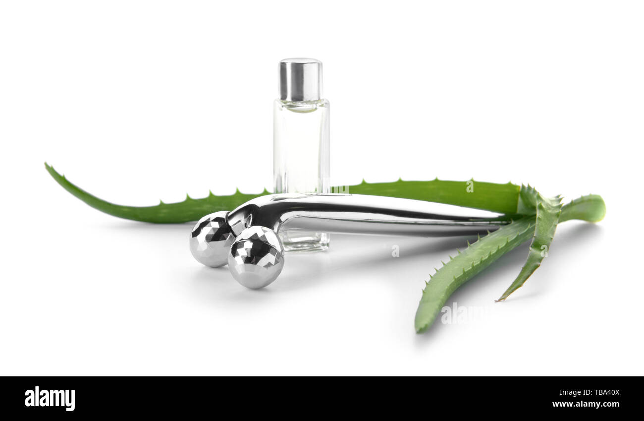 Facial massage tool with essential oil on white background Stock Photo ...