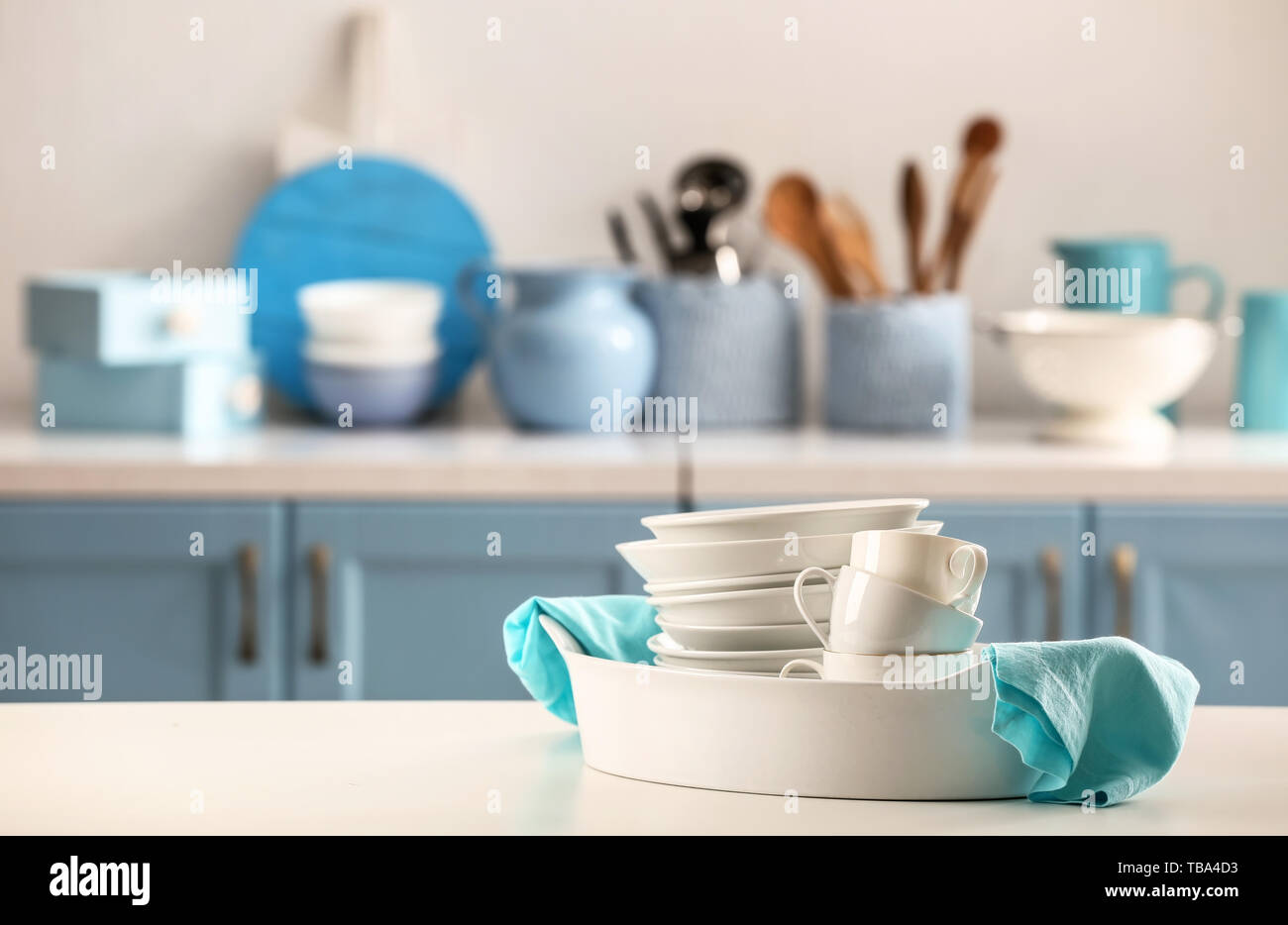 Set of dishware on kitchen table Stock Photo - Alamy