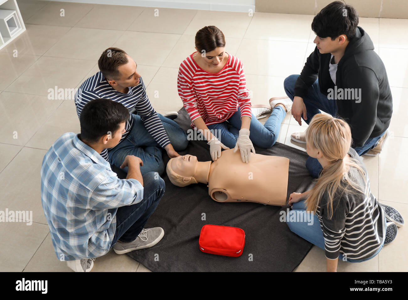 People learning to perform CPR at first aid training course Stock Photo ...