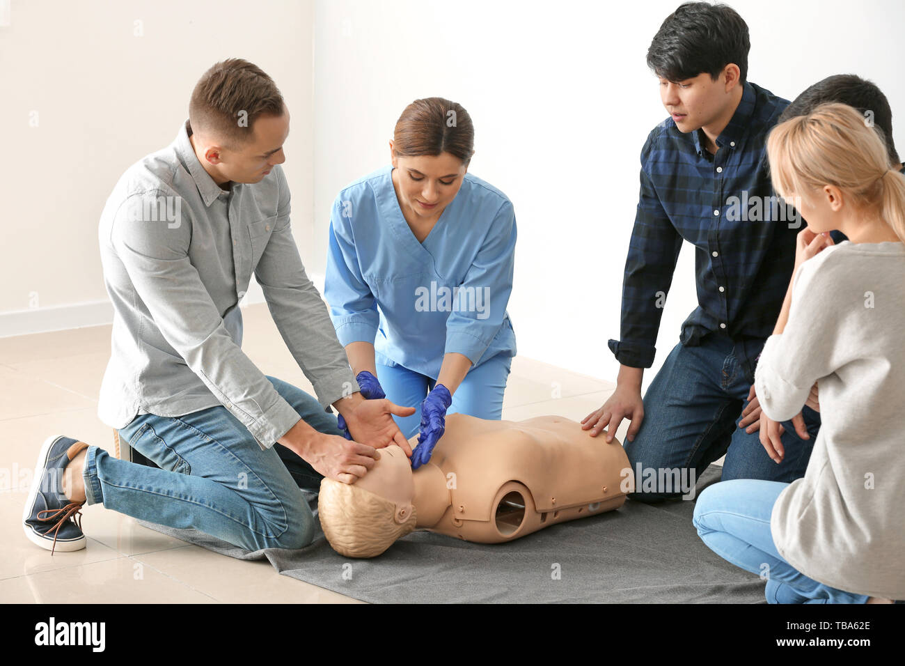 People learning to perform CPR at first aid training course Stock Photo ...