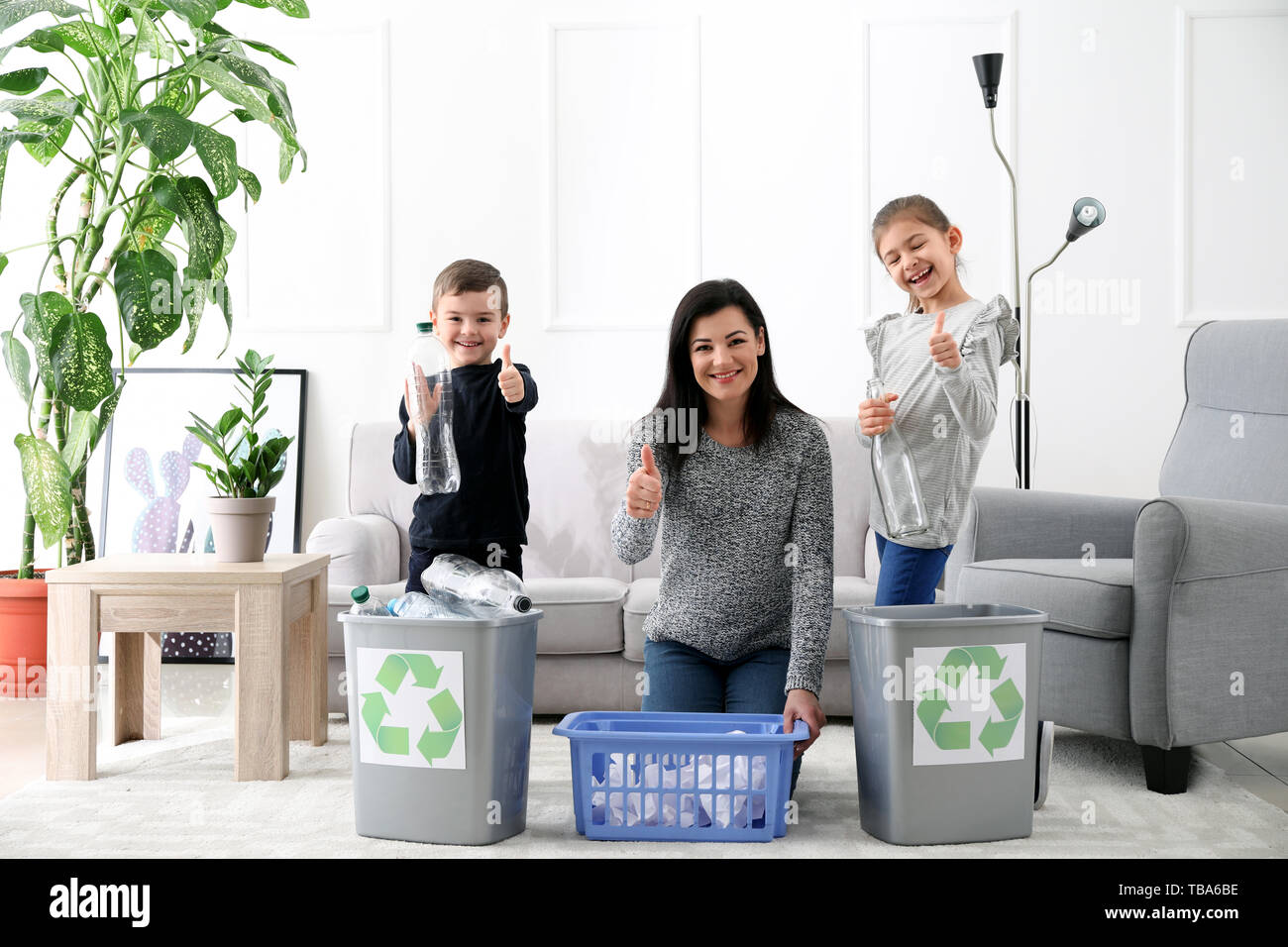 Family sorting garbage at home. Concept of recycling Stock Photo - Alamy