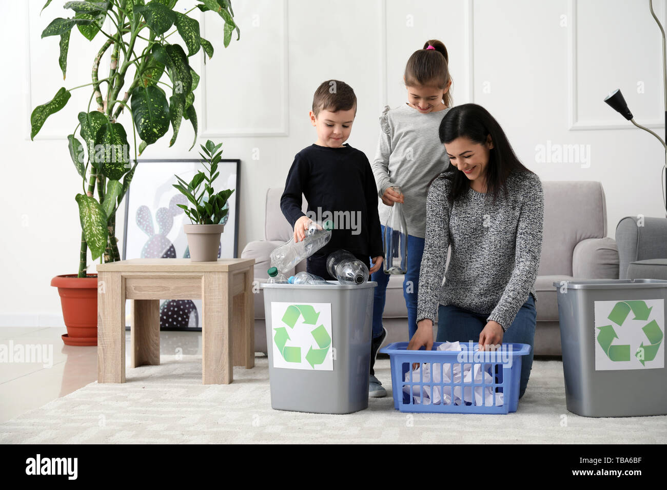 Family sorting garbage at home. Concept of recycling Stock Photo - Alamy