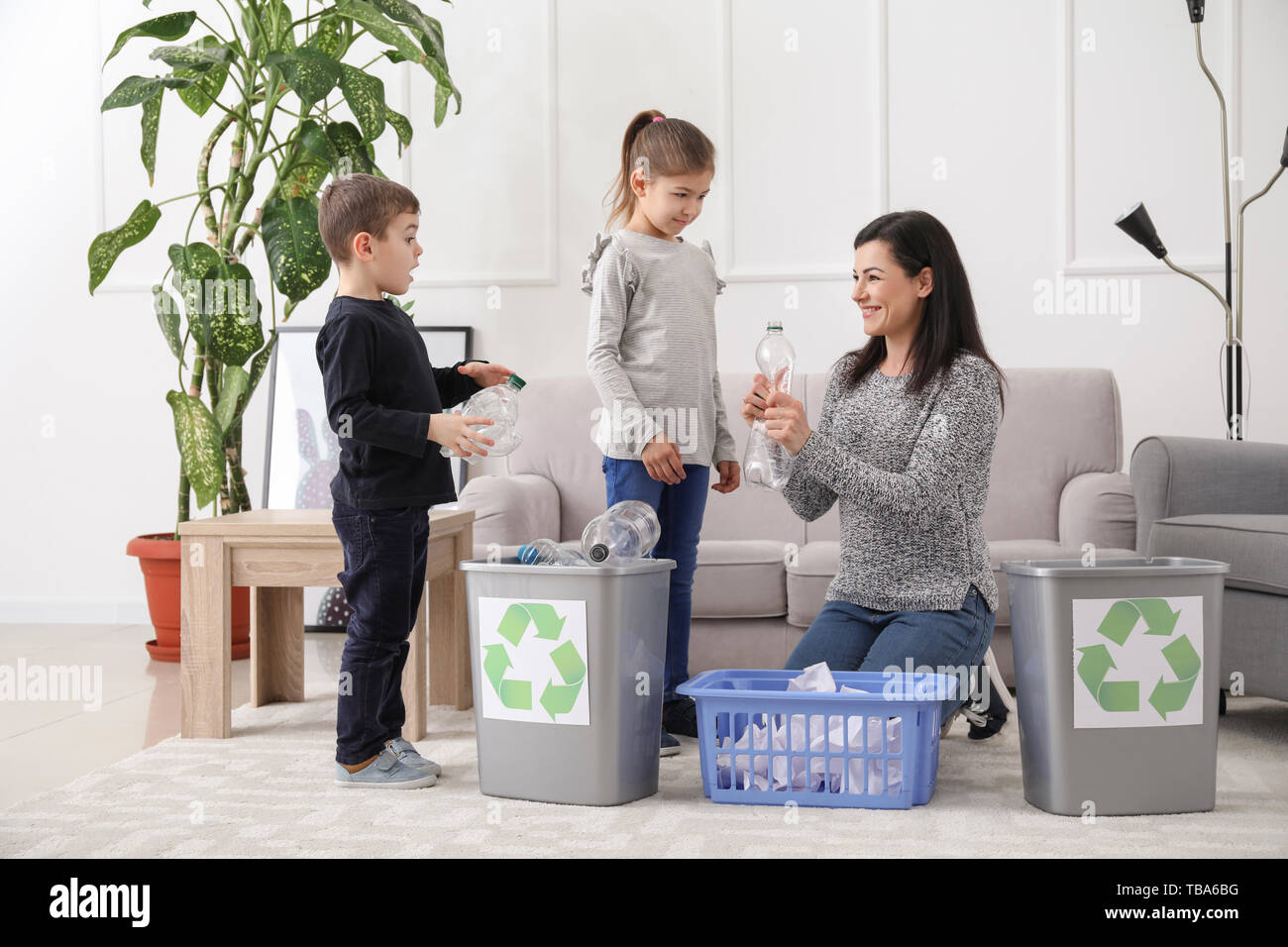 Family sorting garbage at home. Concept of recycling Stock Photo - Alamy