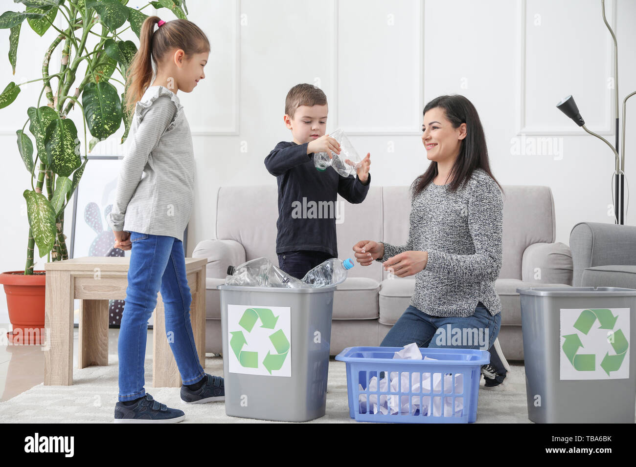 Family sorting garbage at home. Concept of recycling Stock Photo - Alamy