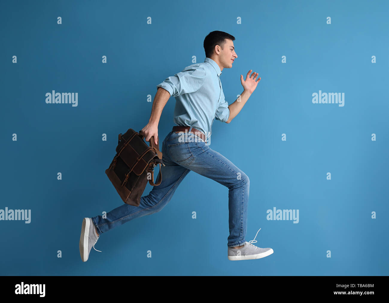 Running man with briefcase on color background Stock Photo - Alamy