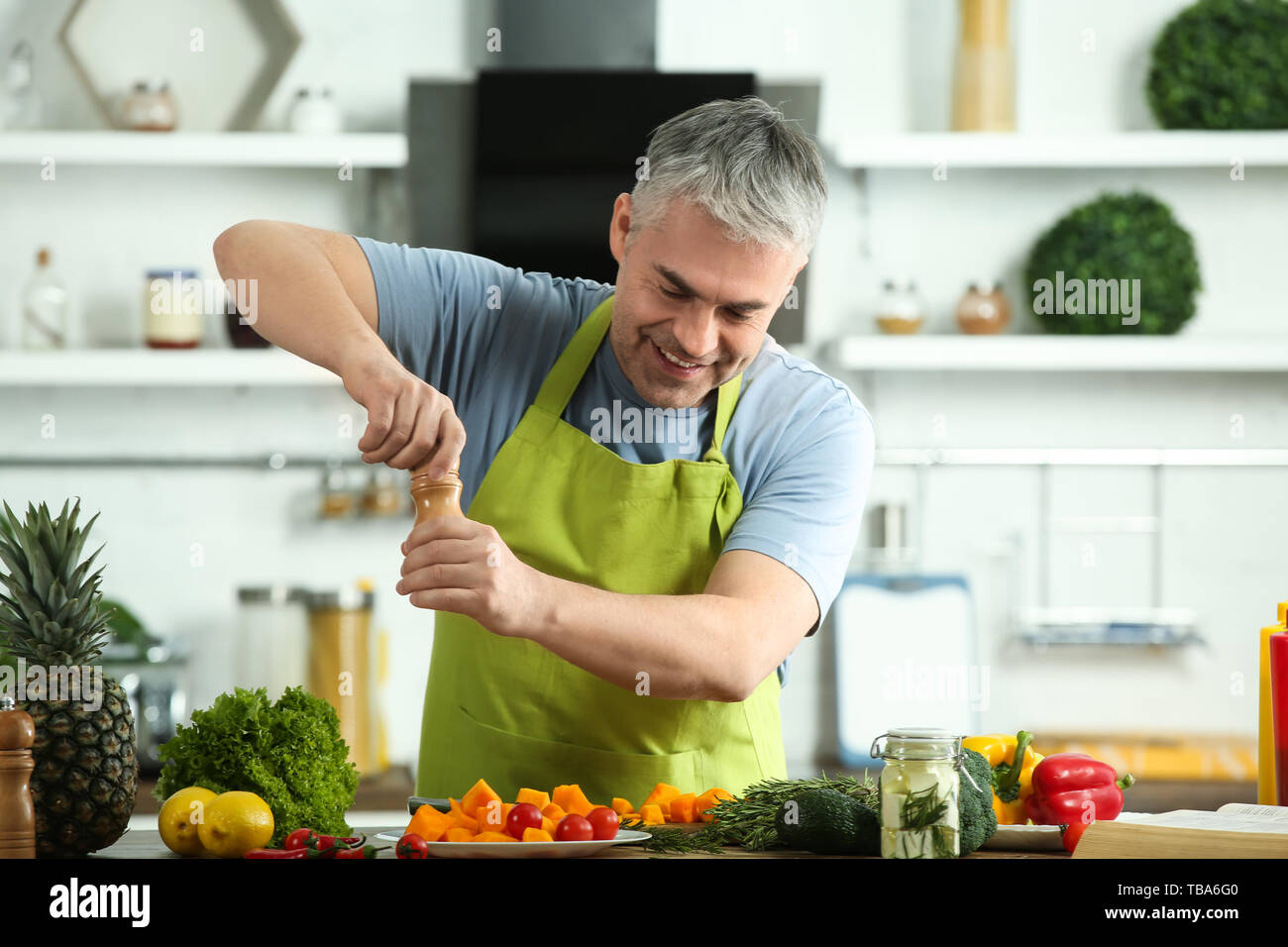 Man home adding salt meal hi-res stock photography and images - Alamy