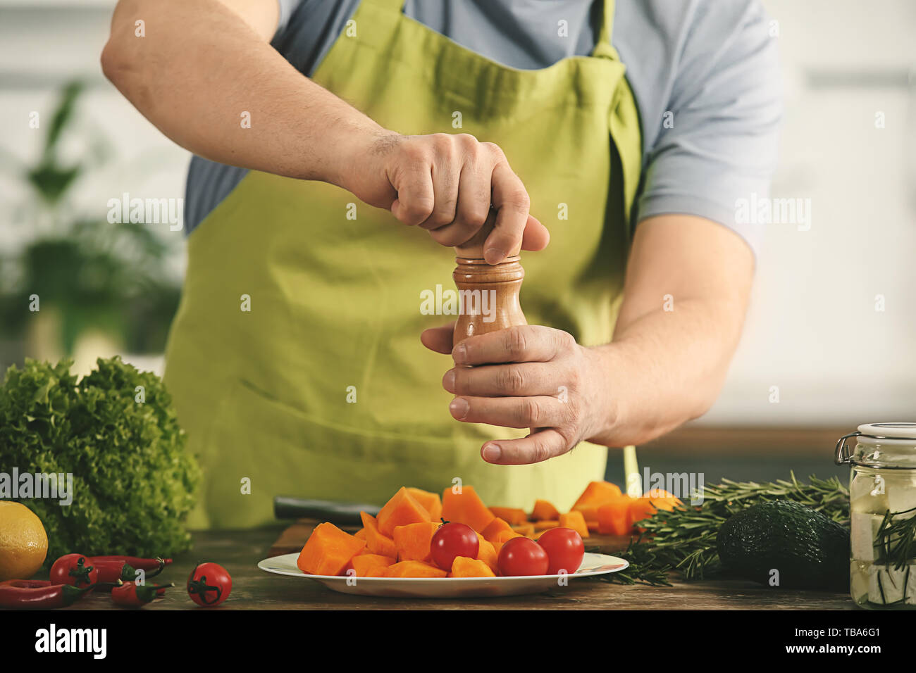 Man home adding salt meal hi-res stock photography and images - Alamy