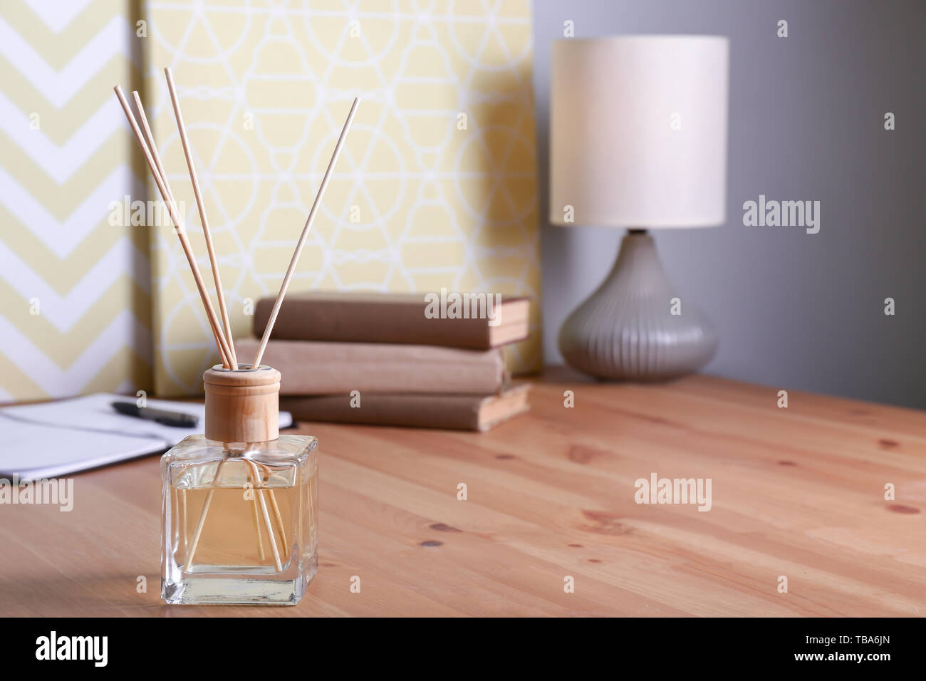 Reed diffuser on table in room Stock Photo - Alamy