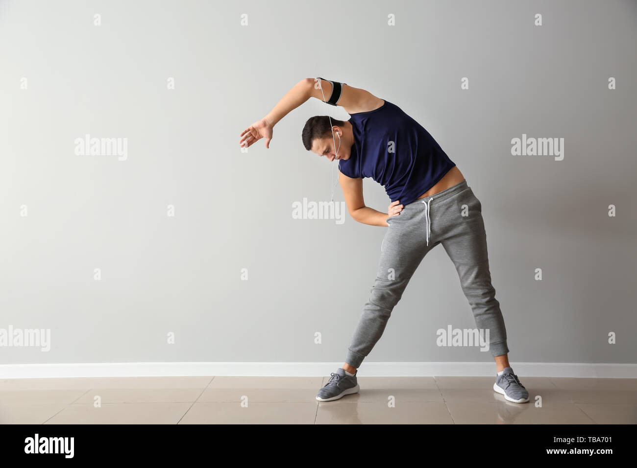 Man stretching against wall hi-res stock photography and images - Alamy