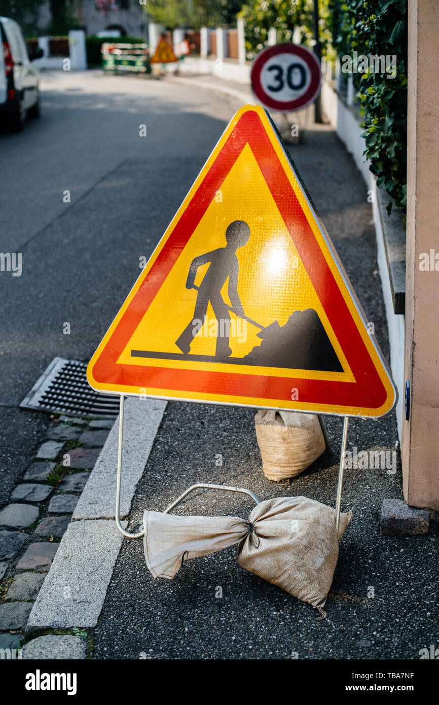 Construction roadworks warning sign on French tiny street Stock Photo ...