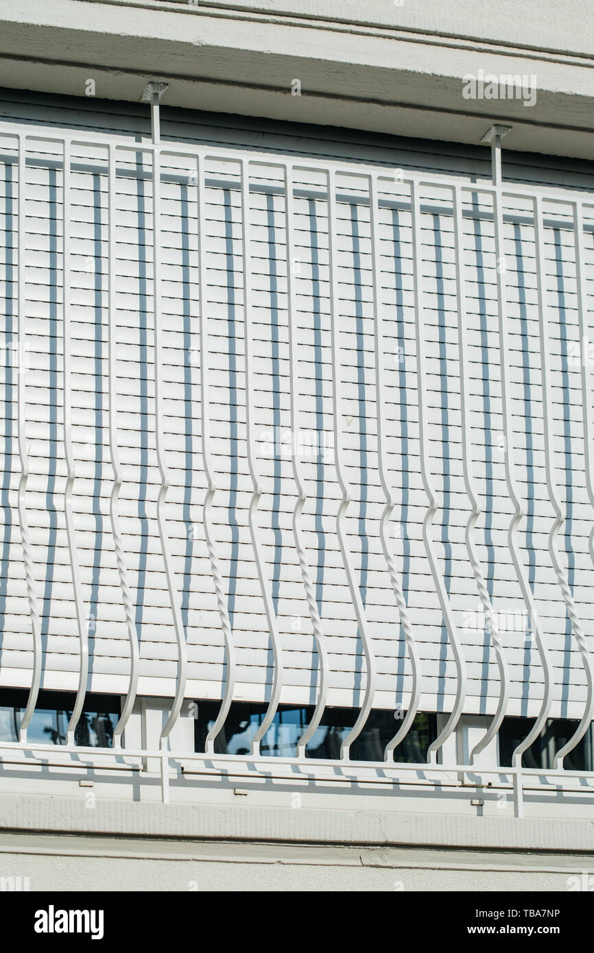 Security white fences bars on the window with white safety shutters ...