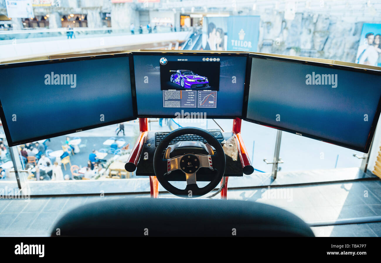 Bucharest, Romania - 2016: Triple screen setup with steering wheel and ...