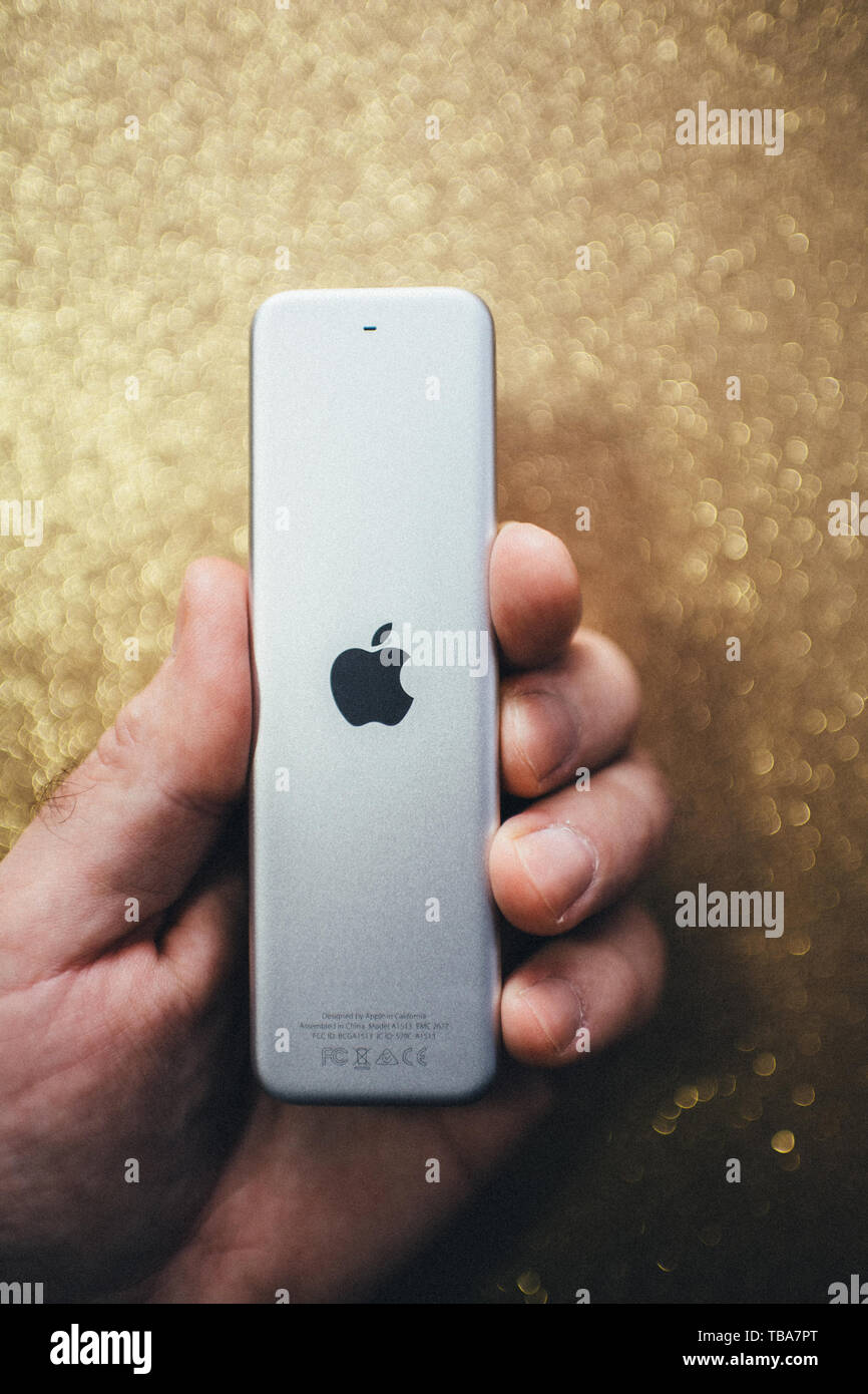 Paris, France - 25 Mar 2019: Man hand holding modern Apple TV 4k player ...