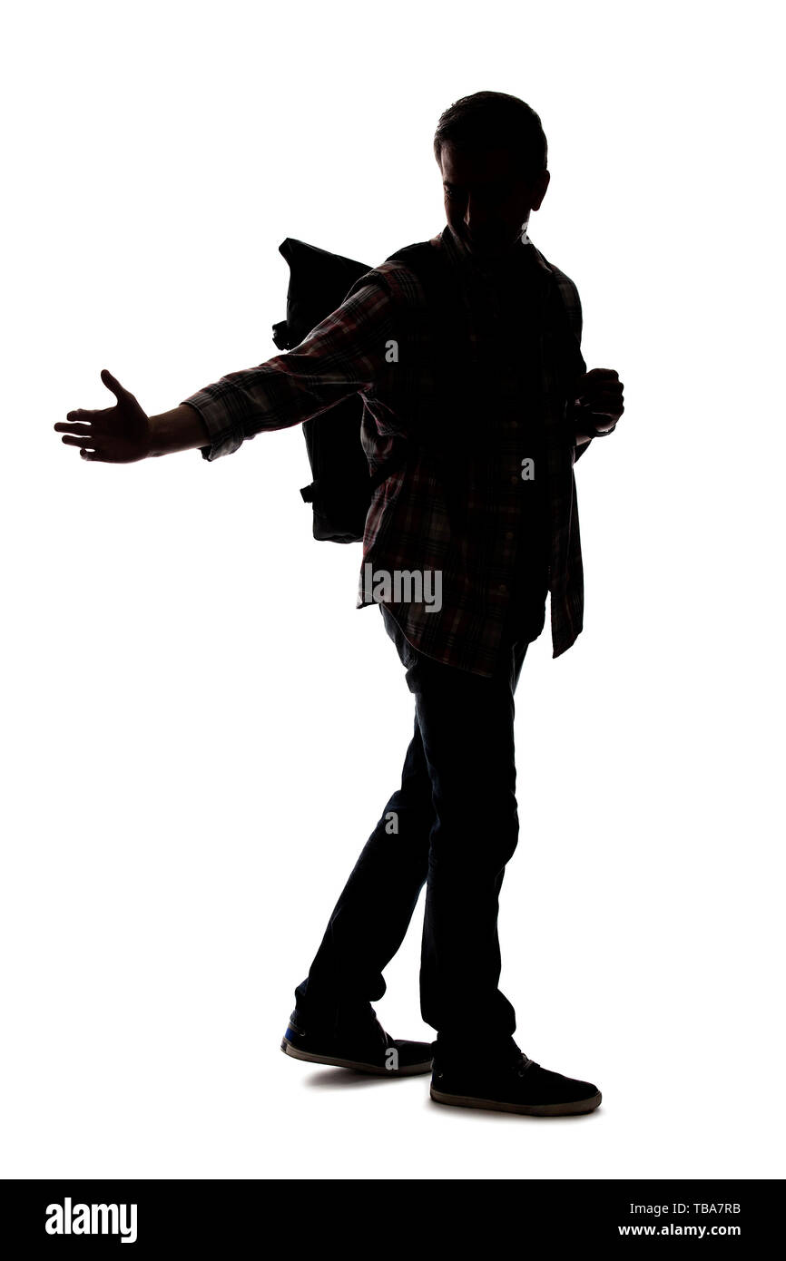 Silhouette of a male tour guide hiking and carrying a backpack on a ...