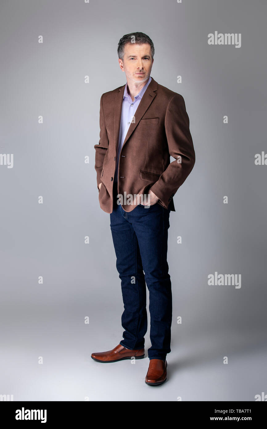 Bearded middle aged fashion model posing with business casual style ...