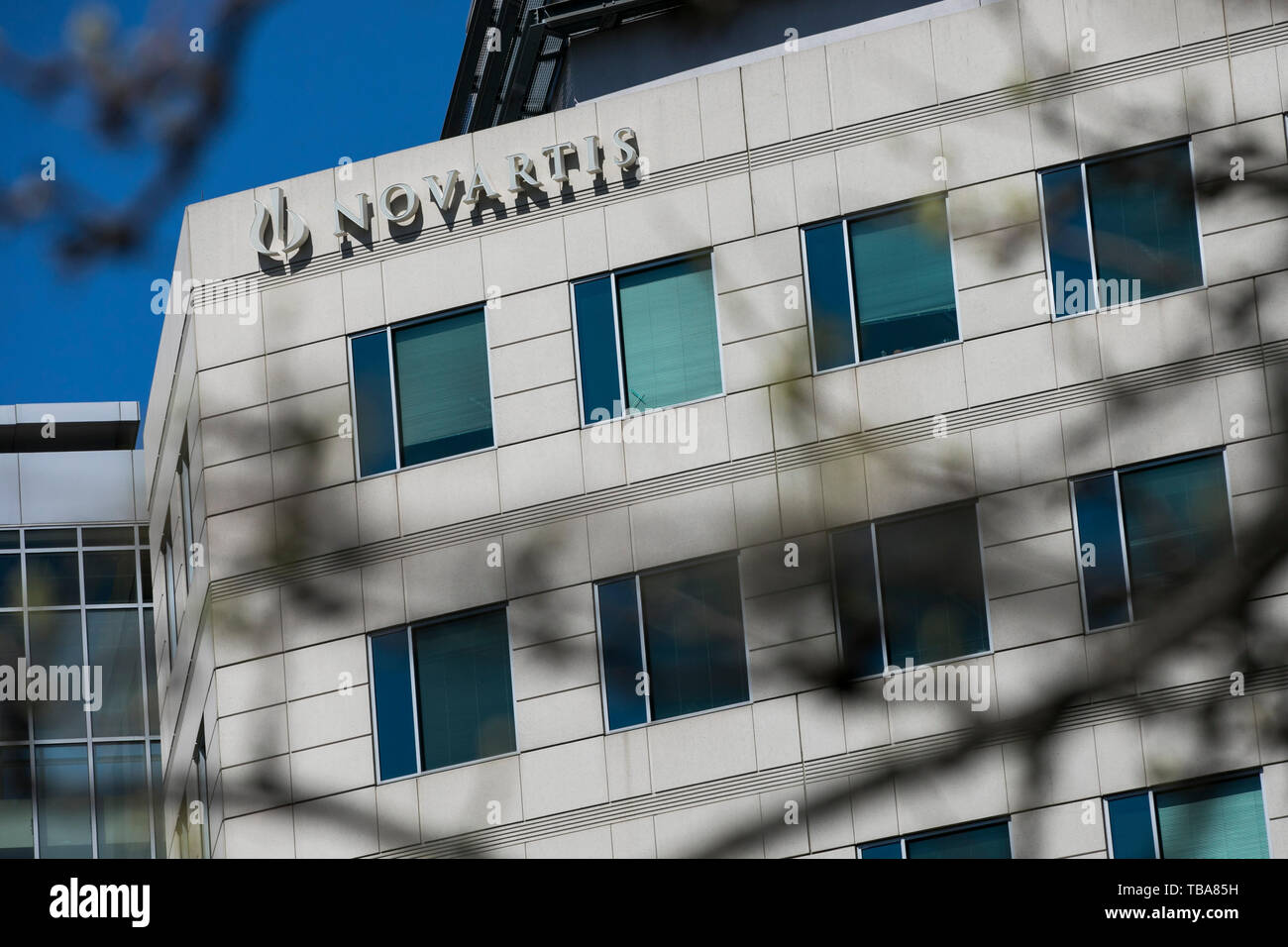 A logo sign outside of a facility occupied by Novartis International in ...