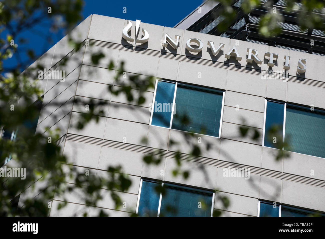 A logo sign outside of a facility occupied by Novartis International in ...