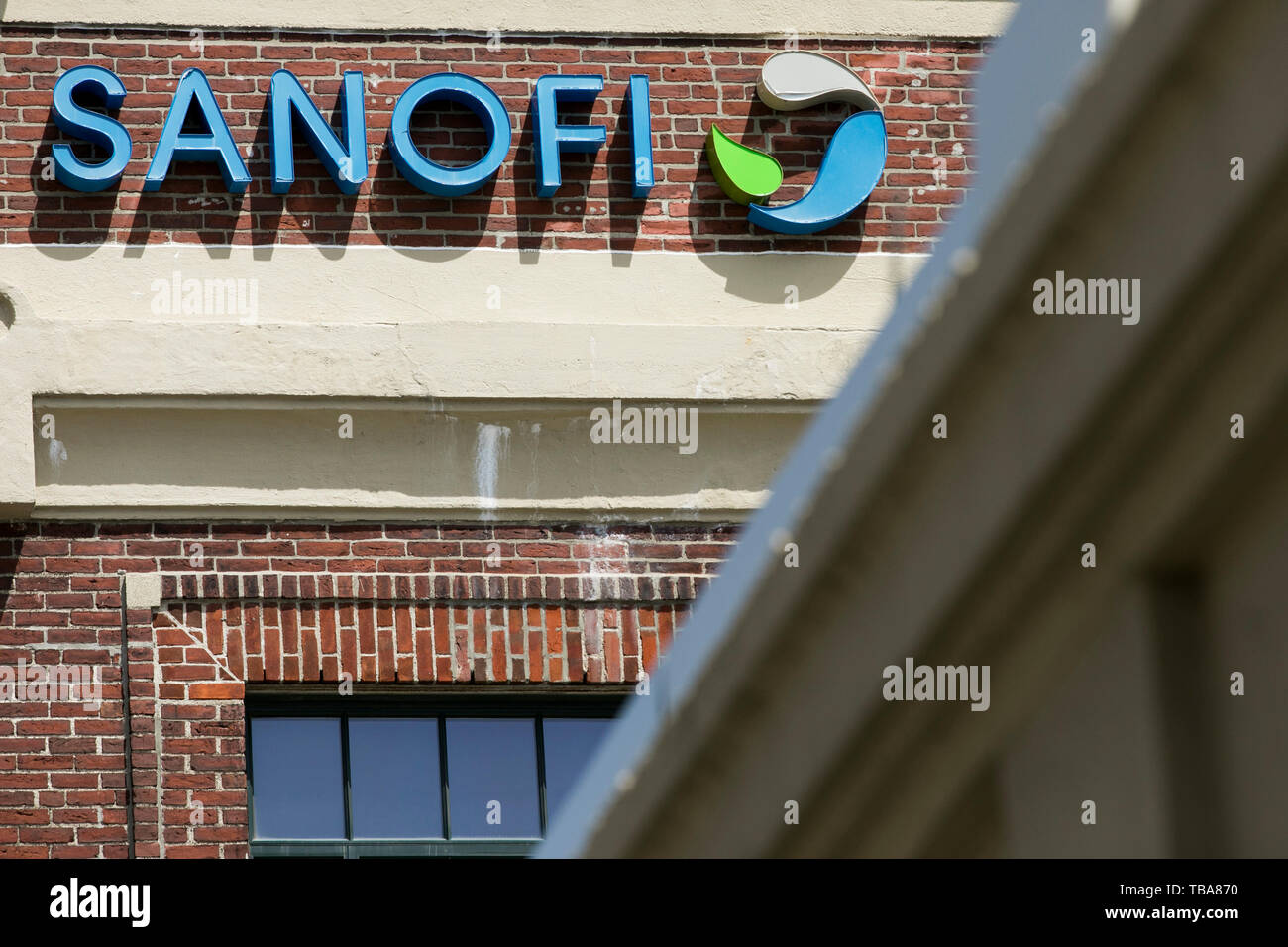 A logo sign outside of a facility occupied by Sanofi in Cambridge ...