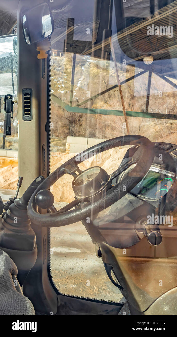 frame Vertical Construction vehicle cab interior with hill and sky in ...