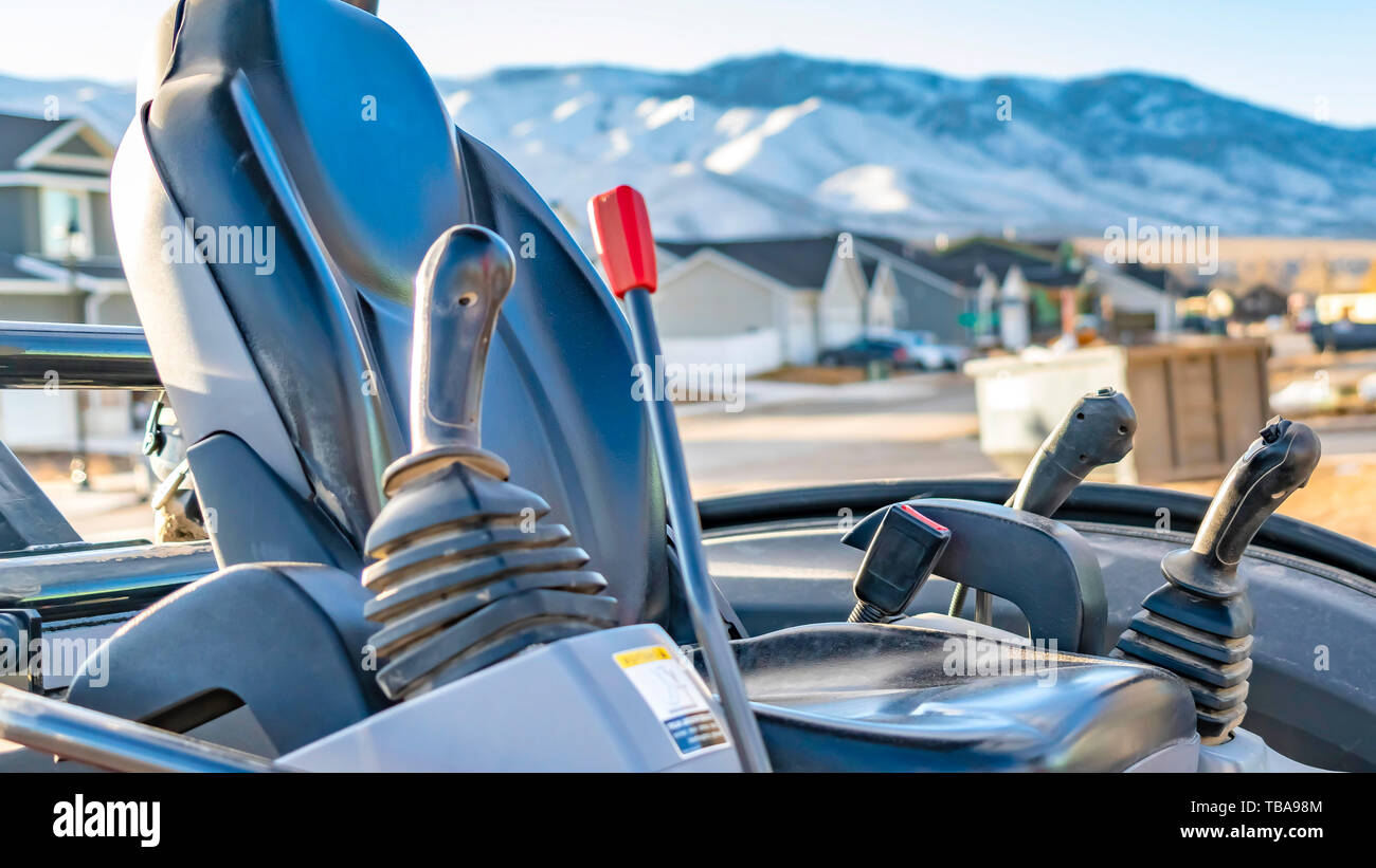 frame Panorama frame Seat and control sticks inside the open cab of a ...