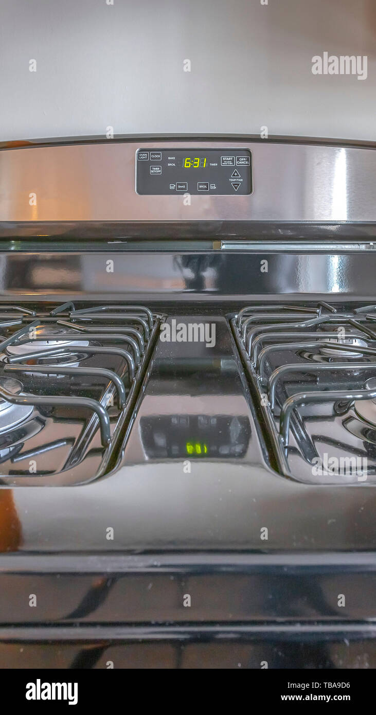 frame Vertical frame Close up of a gas stove with a shiny surface ...