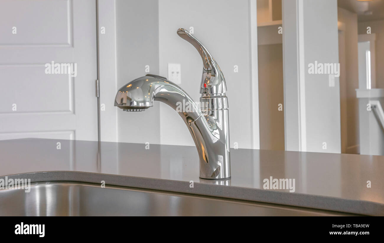 frame Panorama Close up of the shiny sink and faucet inside the kitchen ...