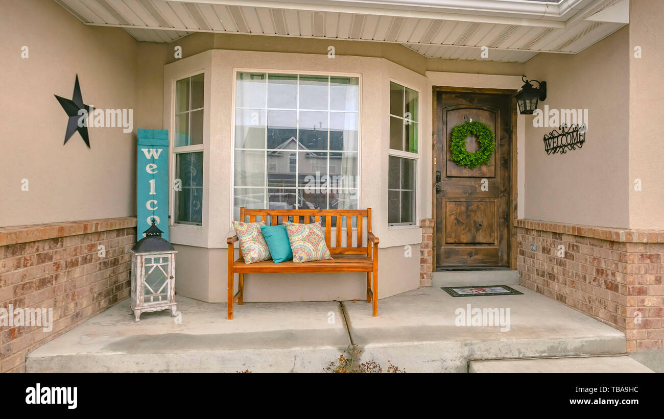 frame Panorama frame Welcoming porch of a home with brown bench in ...